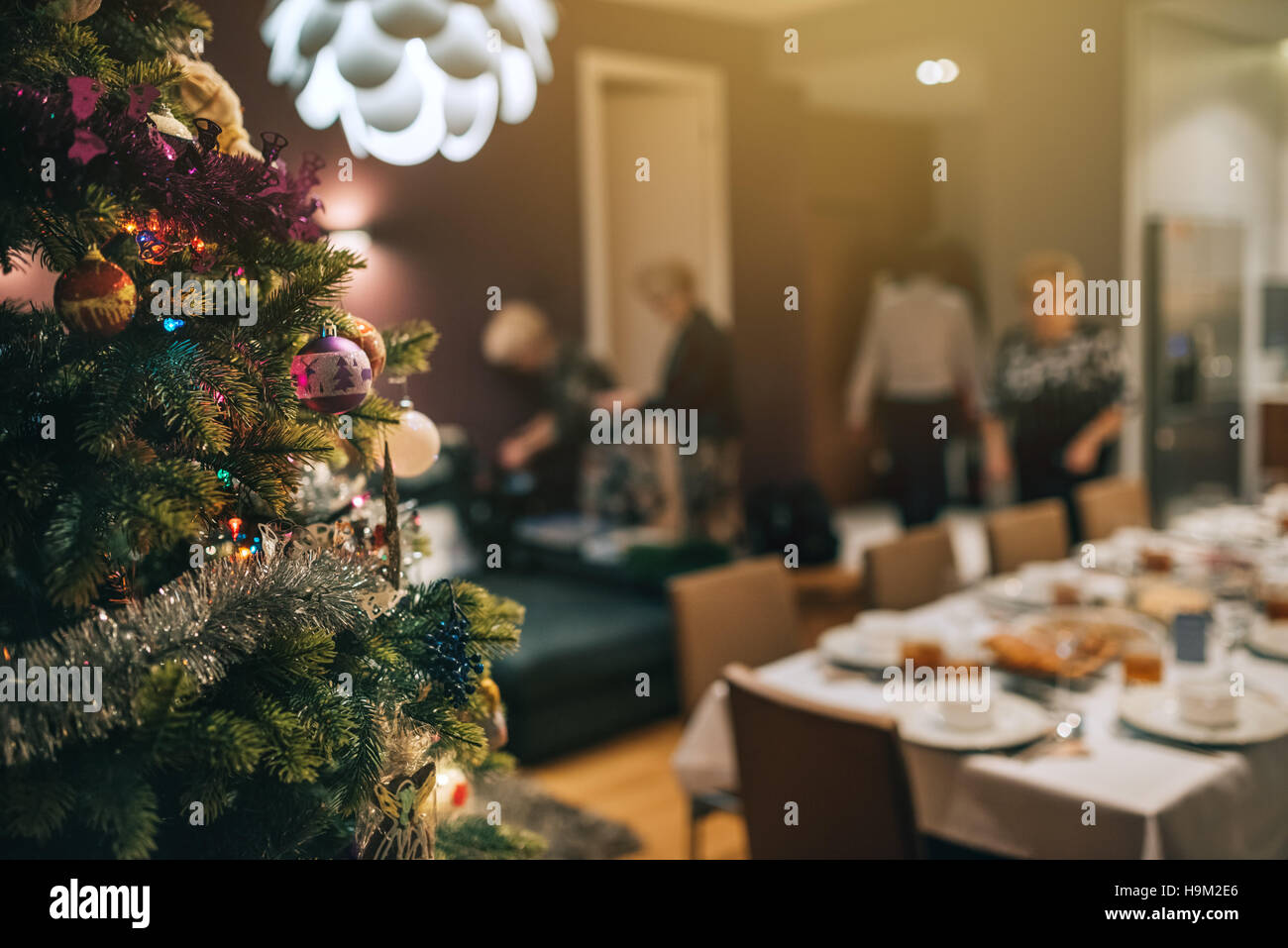 Decorated Christmas tree with people in background Stock Photo - Alamy