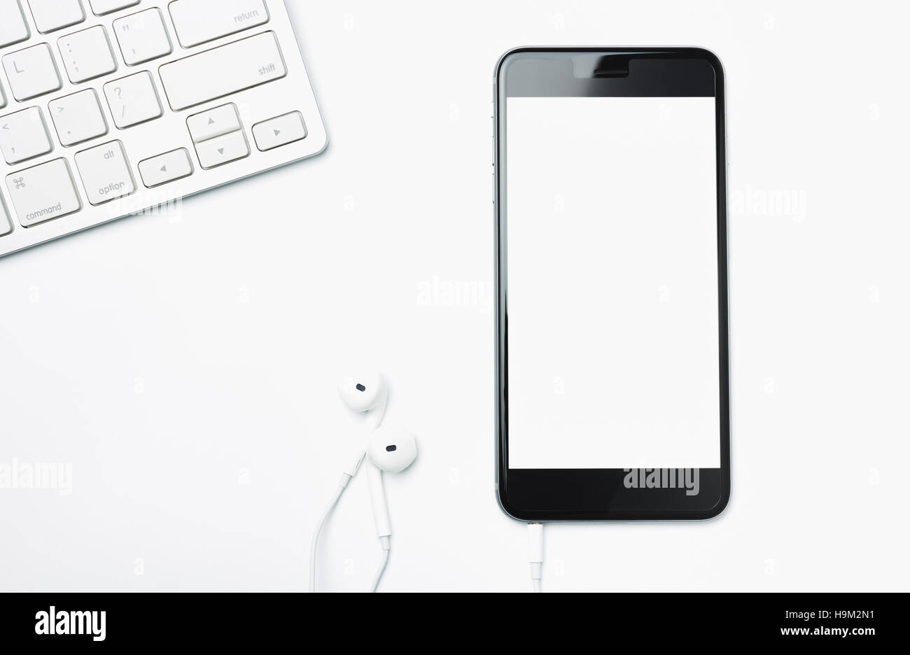 keyboard with smart phone on white background, top view Stock Photo - Alamy