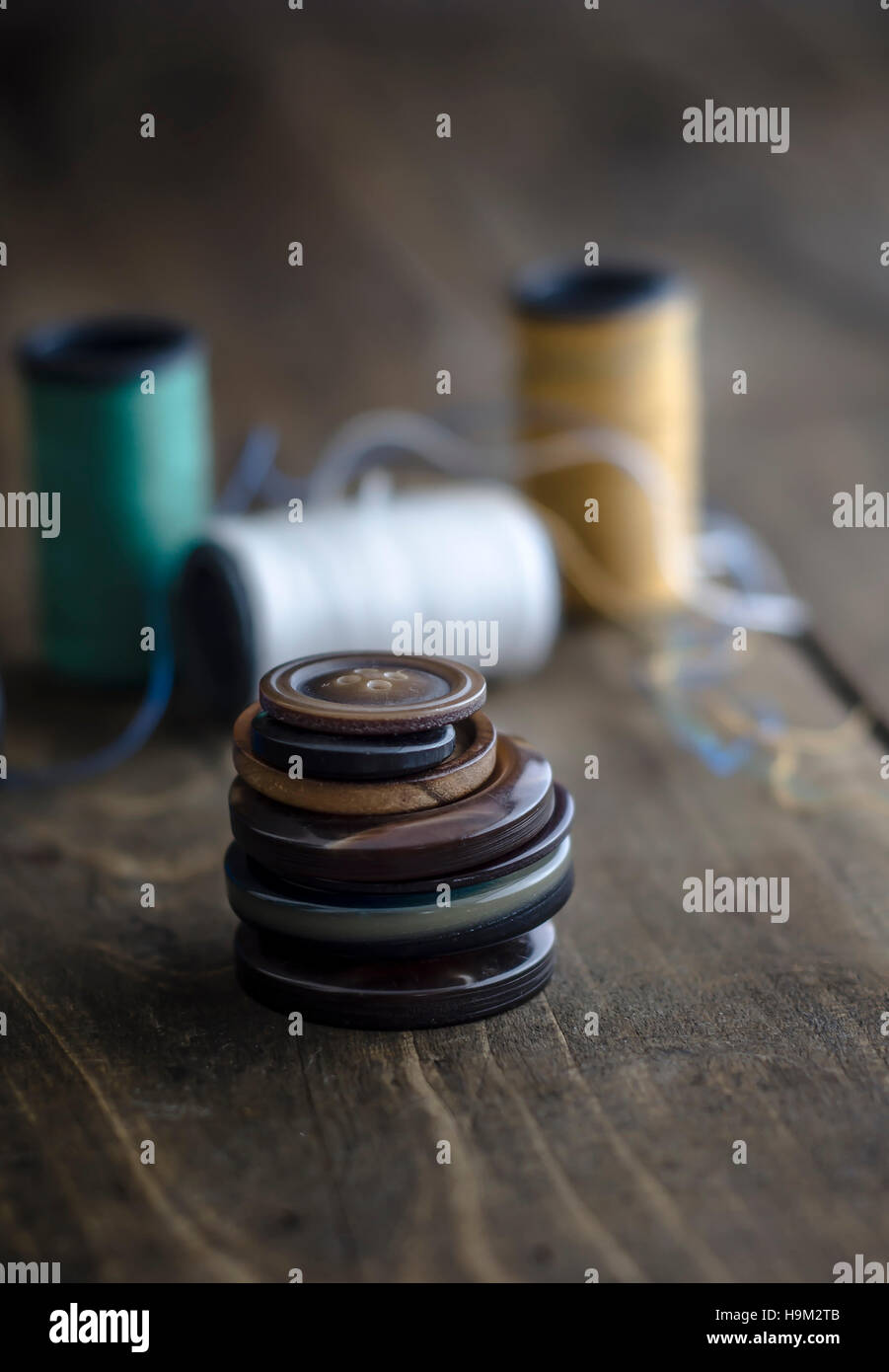Stacked Vintage buttons on wooden background, close up Stock Photo - Alamy