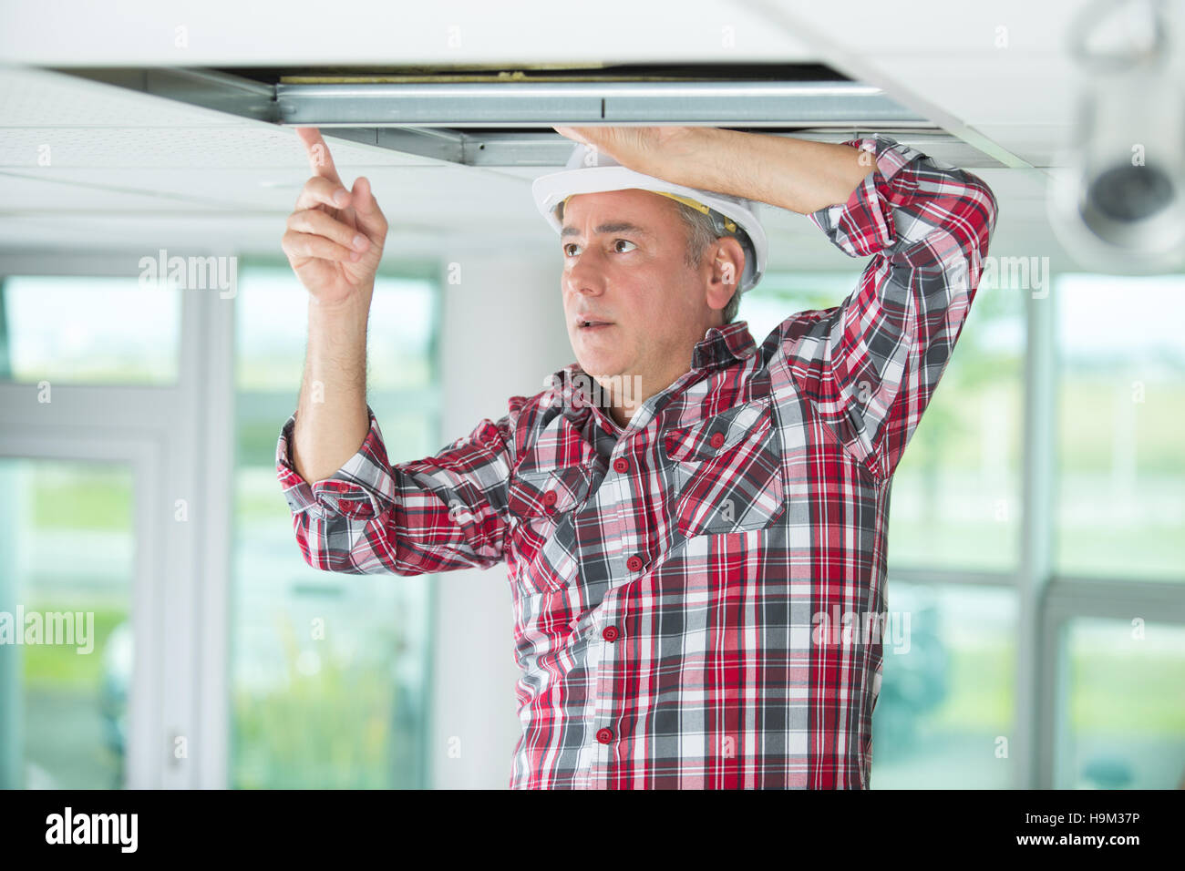 man repairing collapsed ceiling Stock Photo - Alamy