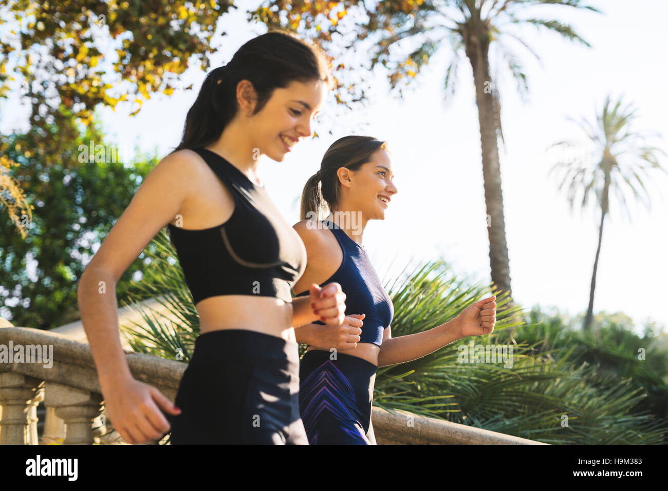 Two smiling young women jogging together Stock Photo - Alamy Two smiling young women jogging together Stock Photo - Alamy