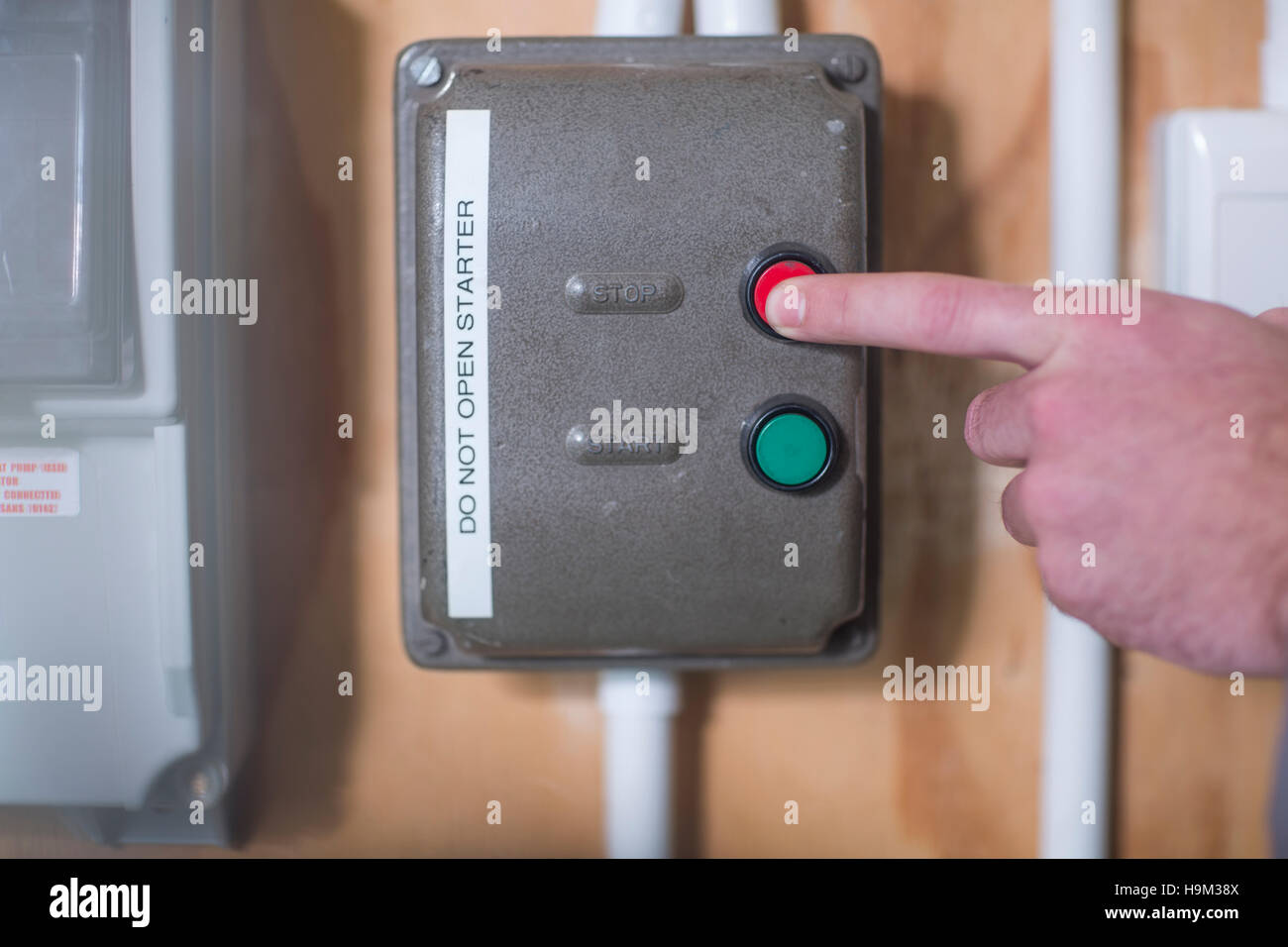 Hand turning off electrical control box Stock Photo - Alamy
