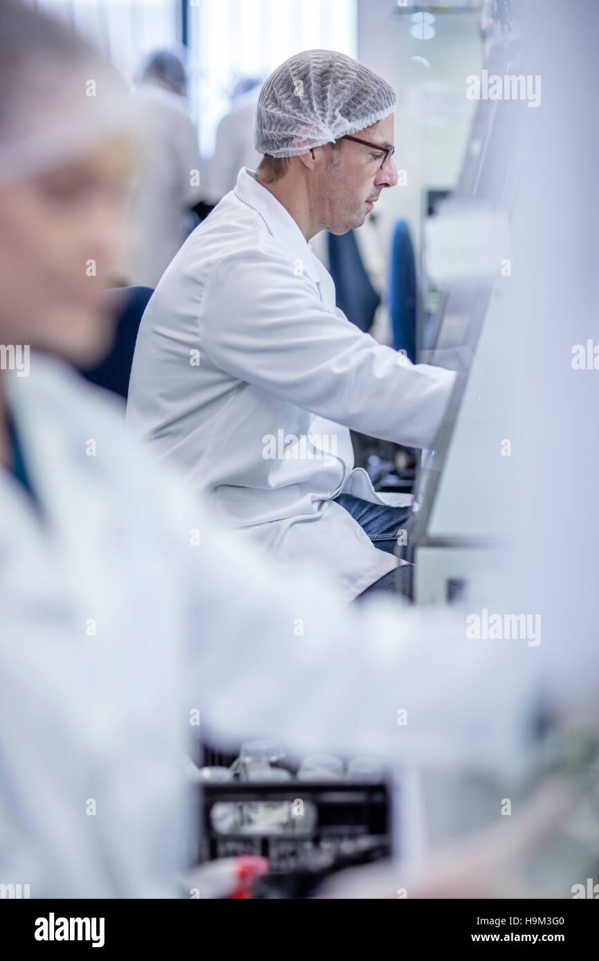 Scientists working in lab wearing protective clothing Stock Photo - Alamy