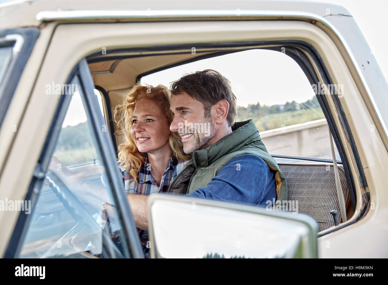 Smiling couple in pick up truck Stock Photo - Alamy