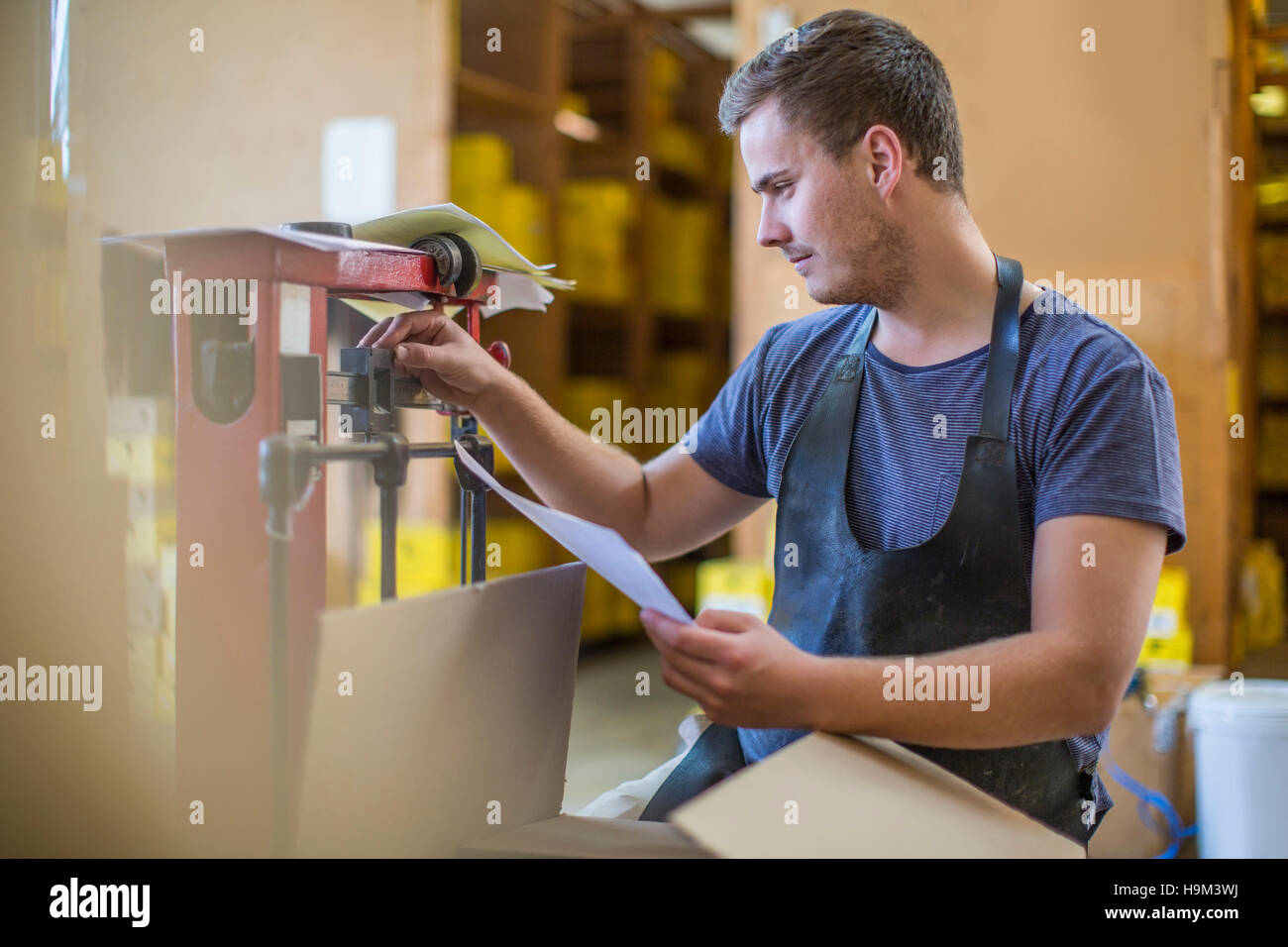 Man in workshop adjusting measuring device Stock Photo - Alamy