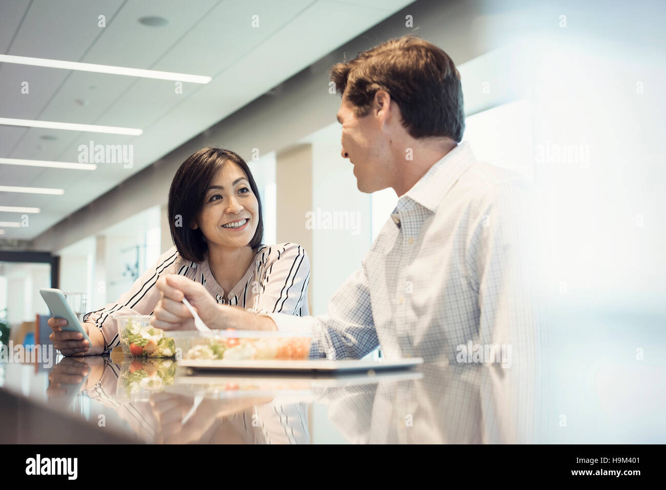 Colleagues in office having lunch together Stock Photo - Alamy