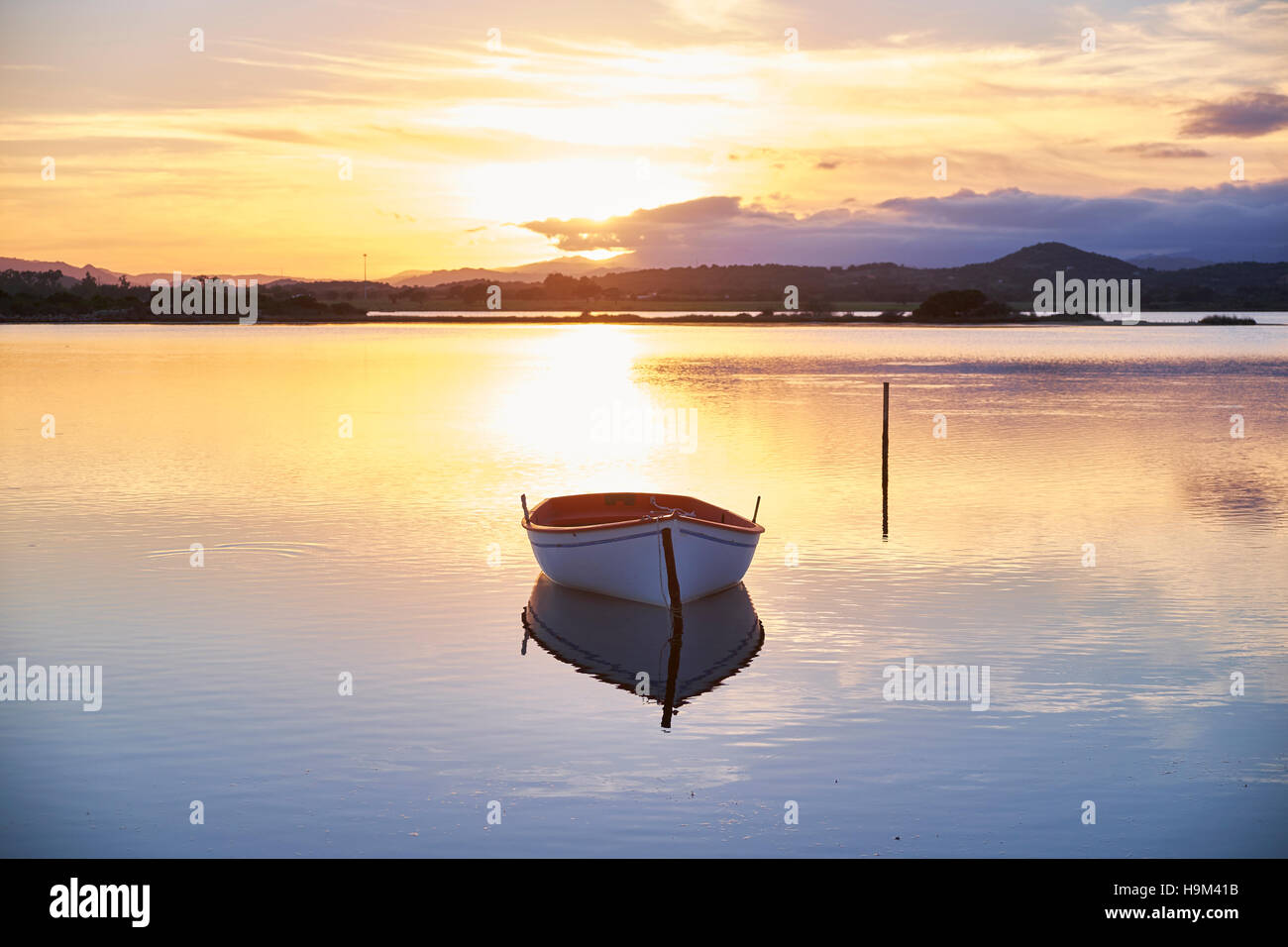 Italy, Sardinia, Murta Maria, boat on the water at sunset Stock Photo ...