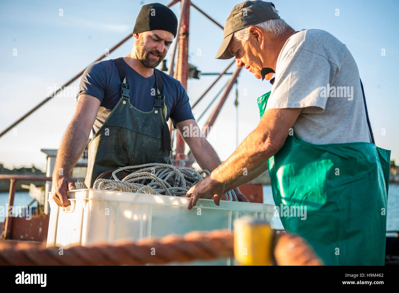 Fishermen working on trawler Stock Photo - Alamy