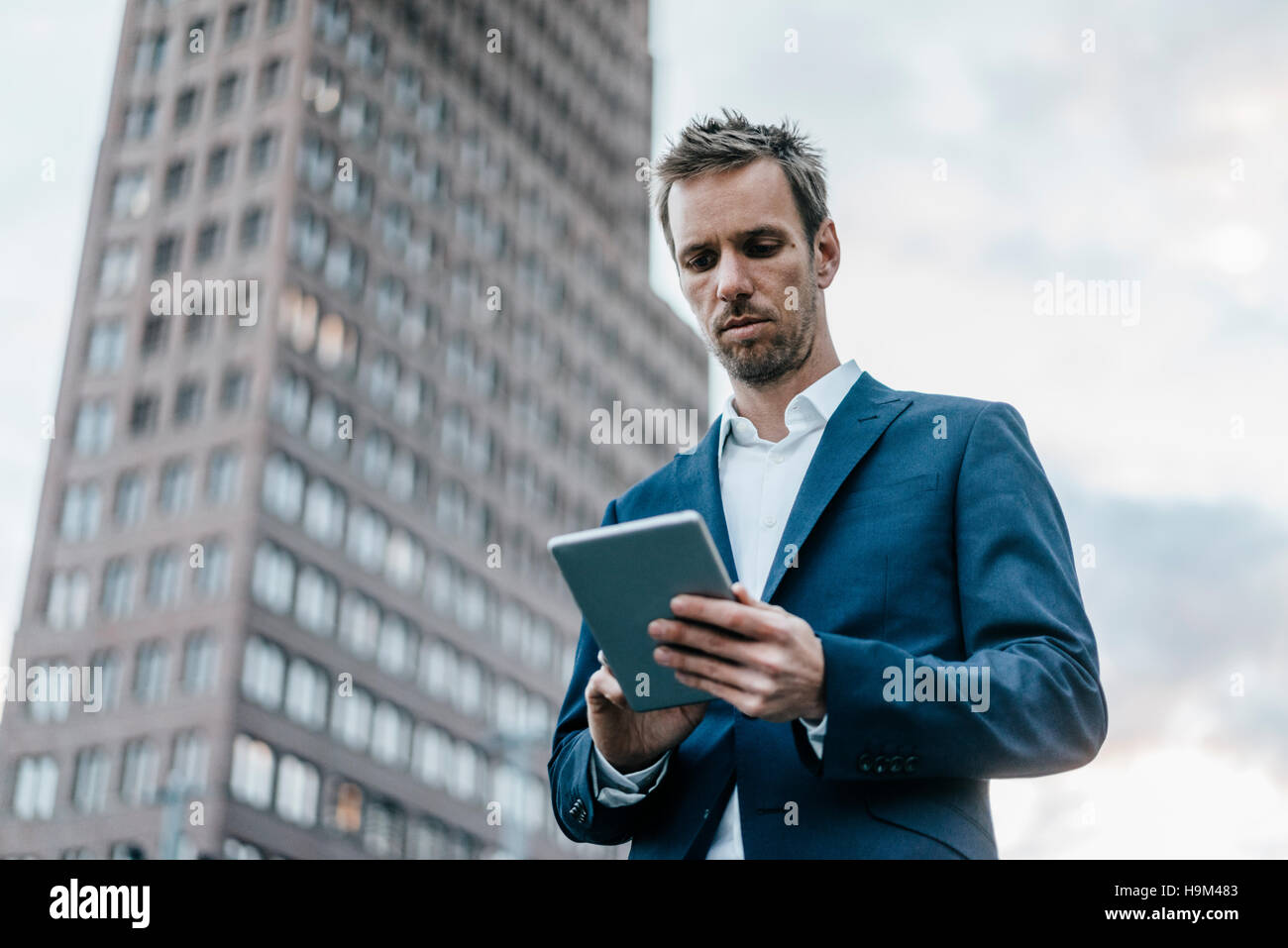 Germany, Berlin, businessman using tablet Stock Photo - Alamy