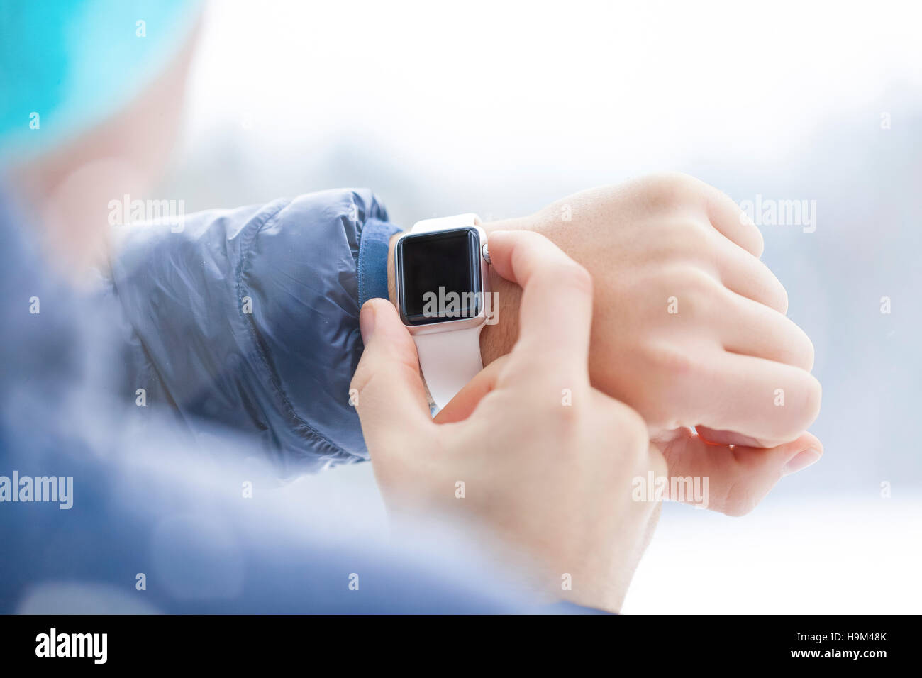 Sportive man checking his smartwatch in winter, close-up Stock Photo ...