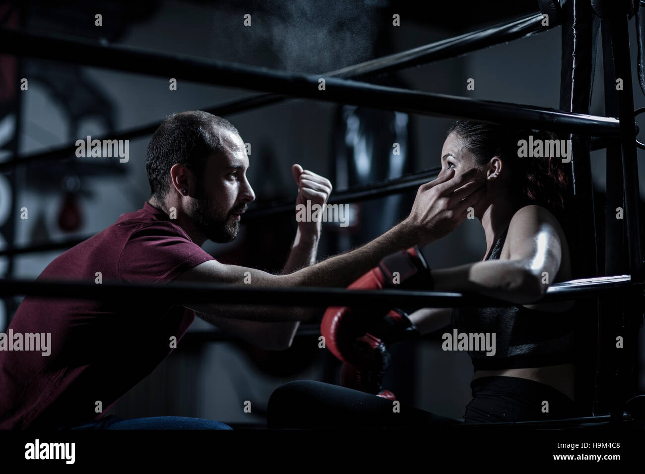 Coach with female boxer in boxing ring Stock Photo - Alamy