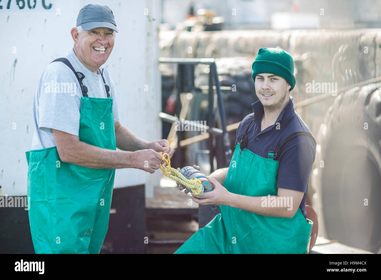 Fishermen working on trawler Stock Photo - Alamy