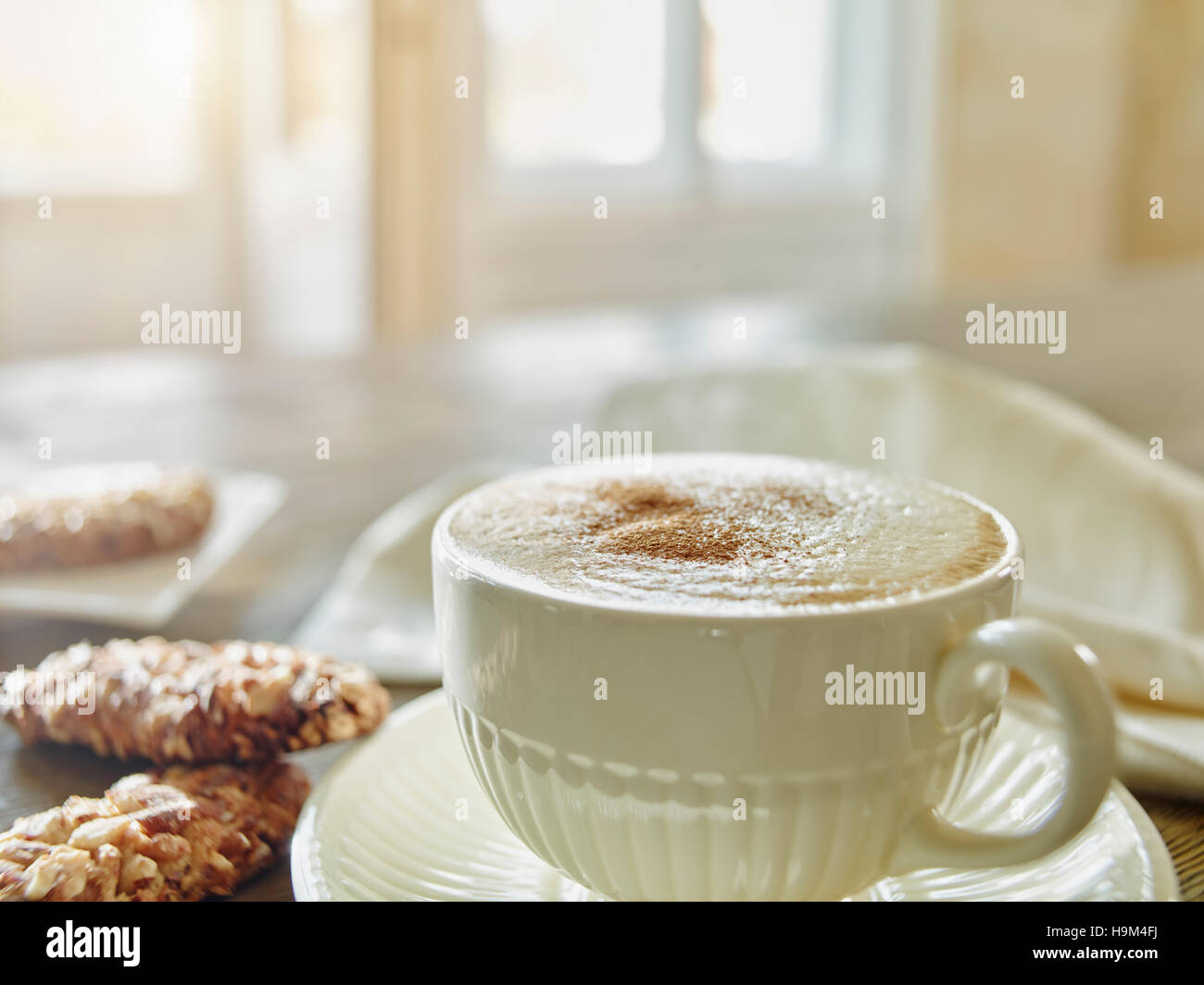 Cup of Cappuccino sprinkled with cinnamon powder Stock Photo - Alamy