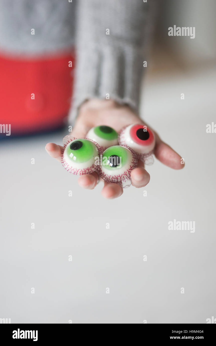 Woman holding artificial sweets eyes Stock Photo - Alamy