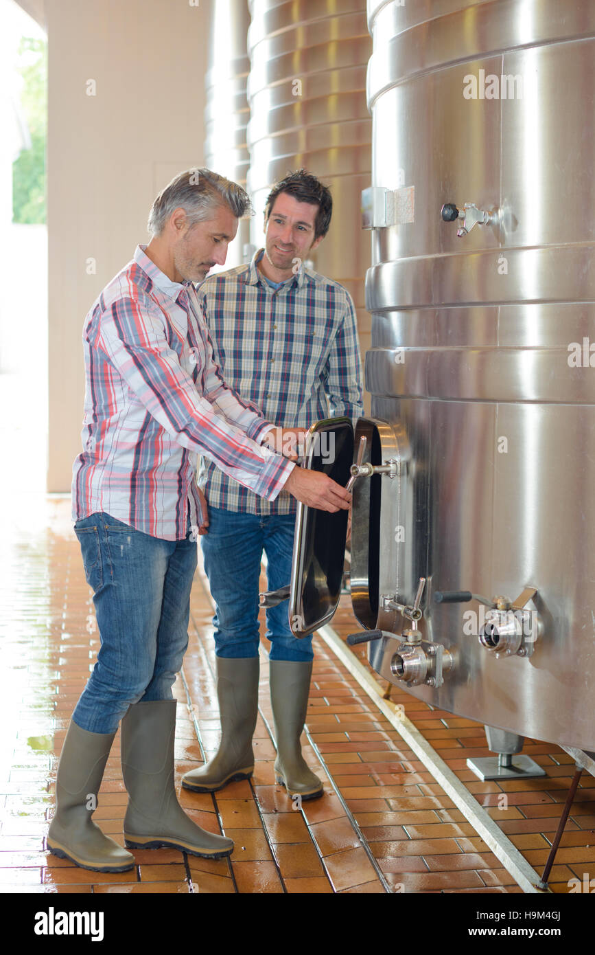 Wine producers in vat room Stock Photo - Alamy