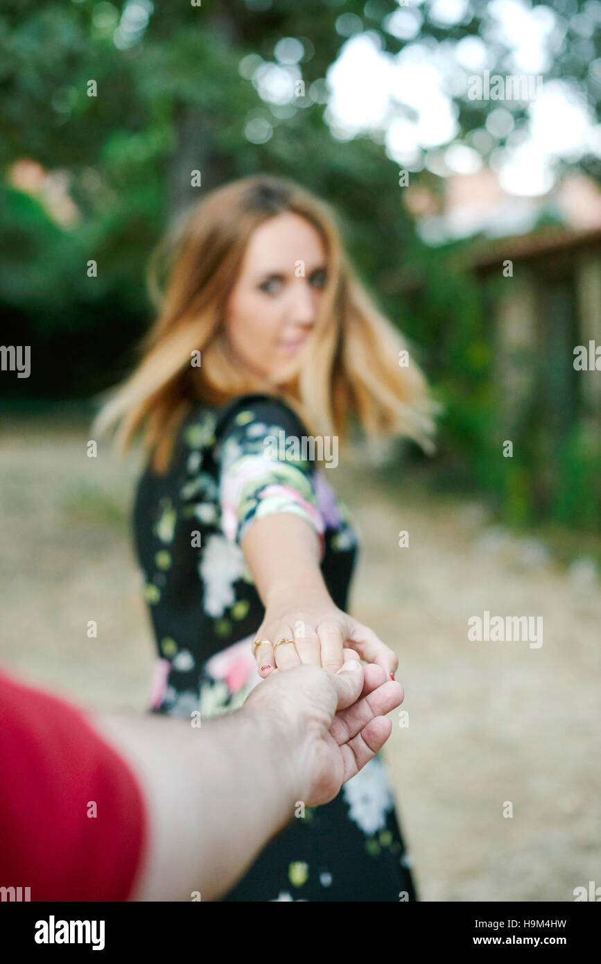 Woman holding man's hand Stock Photo - Alamy