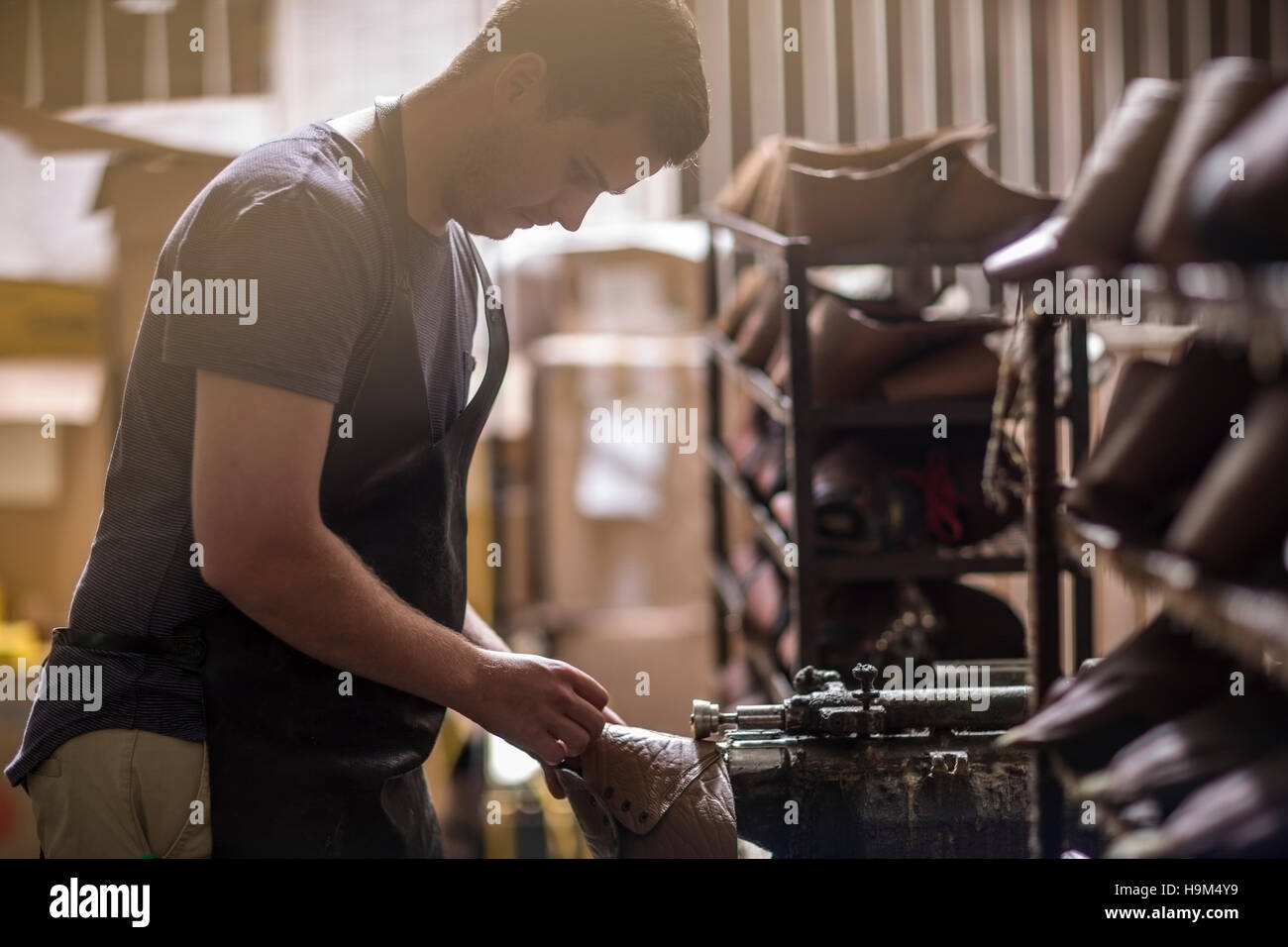Shoemaker working on shoe in workshop Stock Photo - Alamy