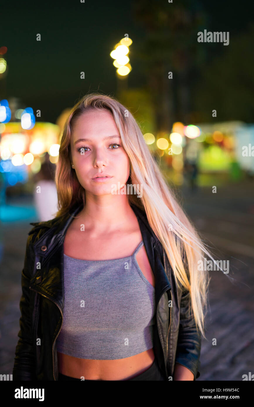 Portrait of a young woman on a funfair at night Stock Photo - Alamy