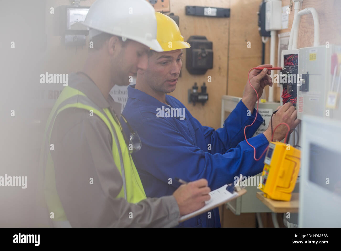 Two electricians working on electrical panel Stock Photo - Alamy