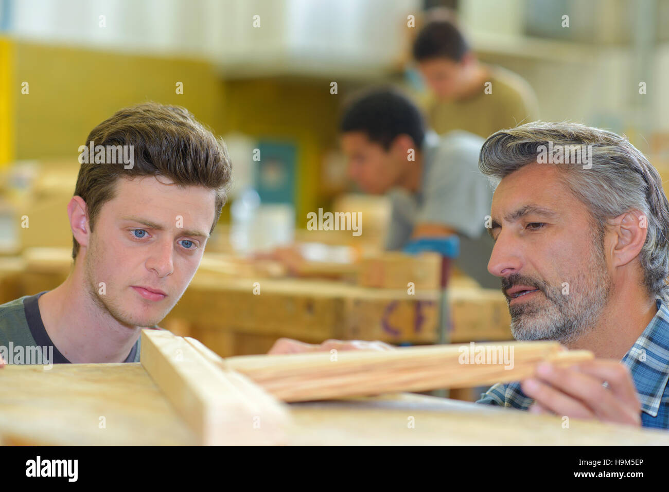 Teacher teaching student carpentry hi-res stock photography and images ...