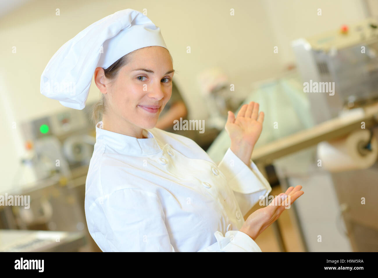 Chef proudly showing her kitchen Stock Photo - Alamy