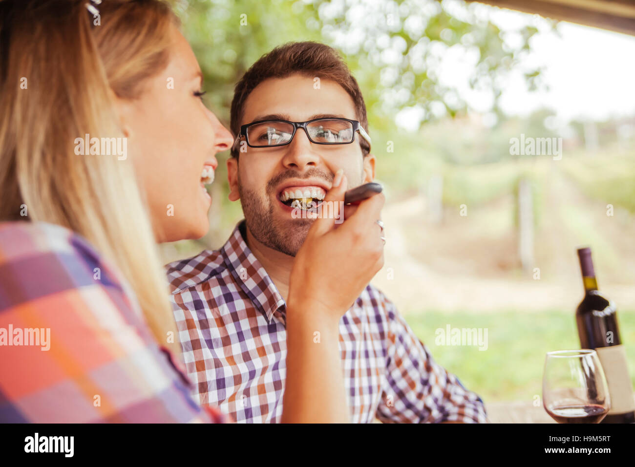 Woman feeding man outdoors Stock Photo - Alamy