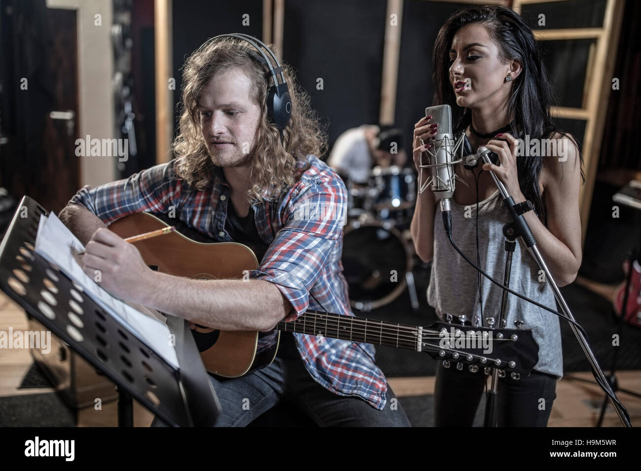 Singer and guitarist in recording studio Stock Photo - Alamy