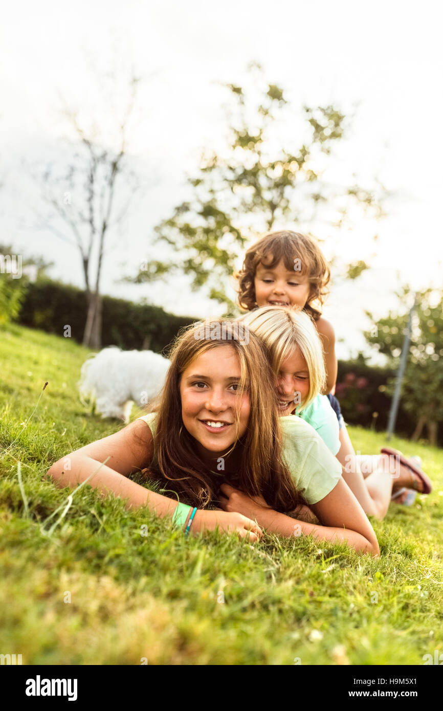Three girls having fun together on a meadow Stock Photo - Alamy