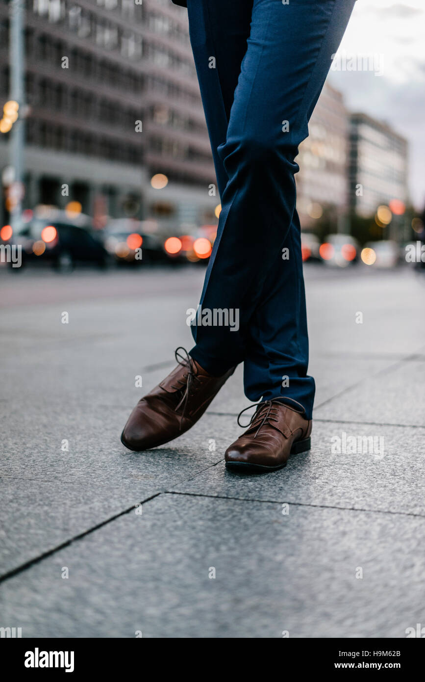 Businessman standing on pavement, partial view Stock Photo - Alamy