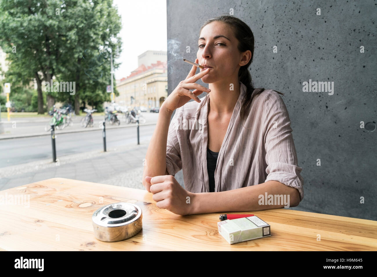 Young woman smoking Stock Photo - Alamy