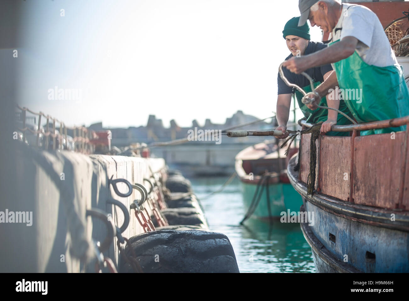 Fishermen working on trawler Stock Photo - Alamy