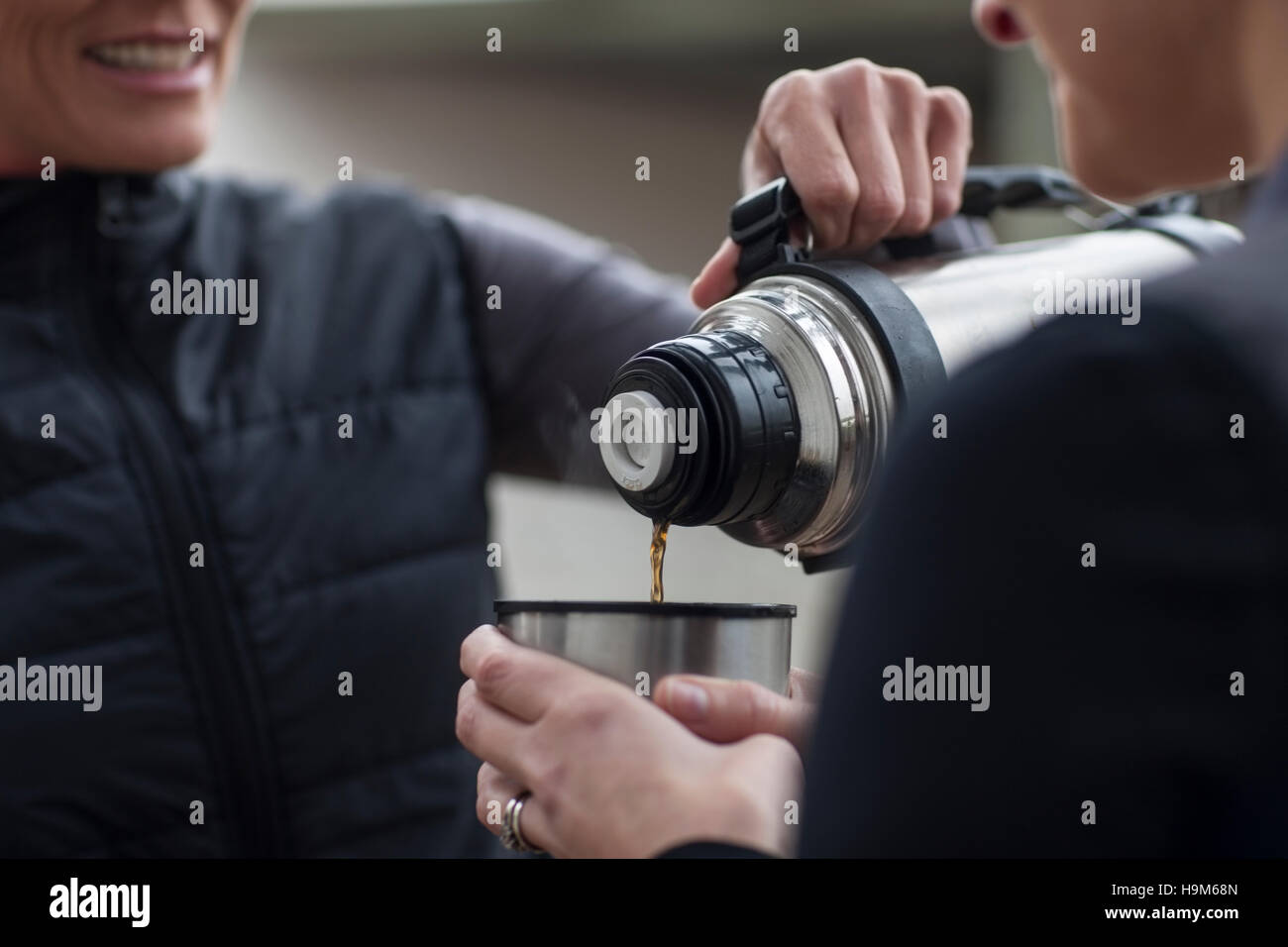 Two women having a coffee break Stock Photo - Alamy