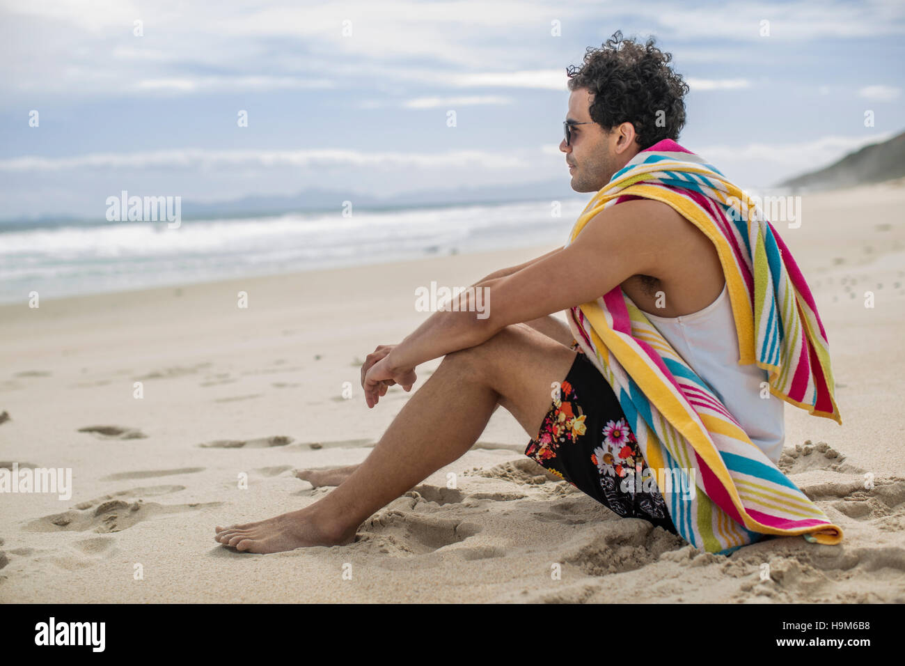 Relaxed man sitting beach looking view hi-res stock photography and ...
