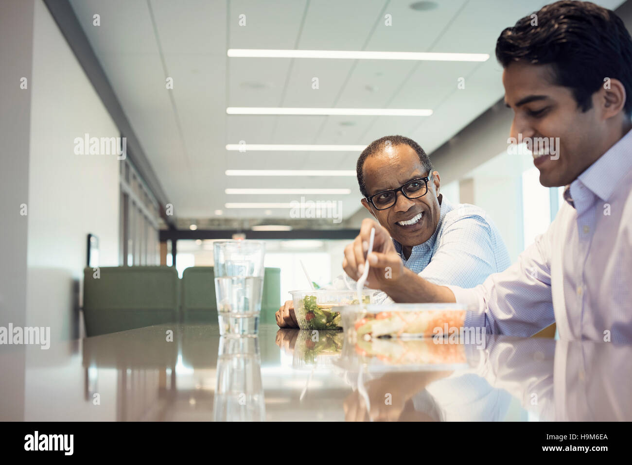 Colleagues in office having lunch together Stock Photo - Alamy