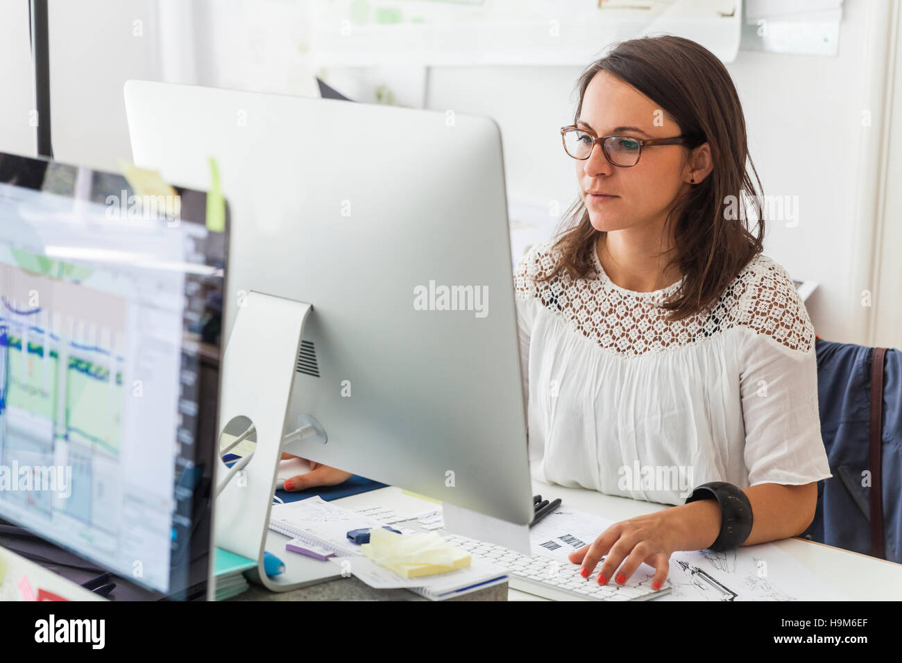 Landscape architect working with computer at desk Stock Photo - Alamy
