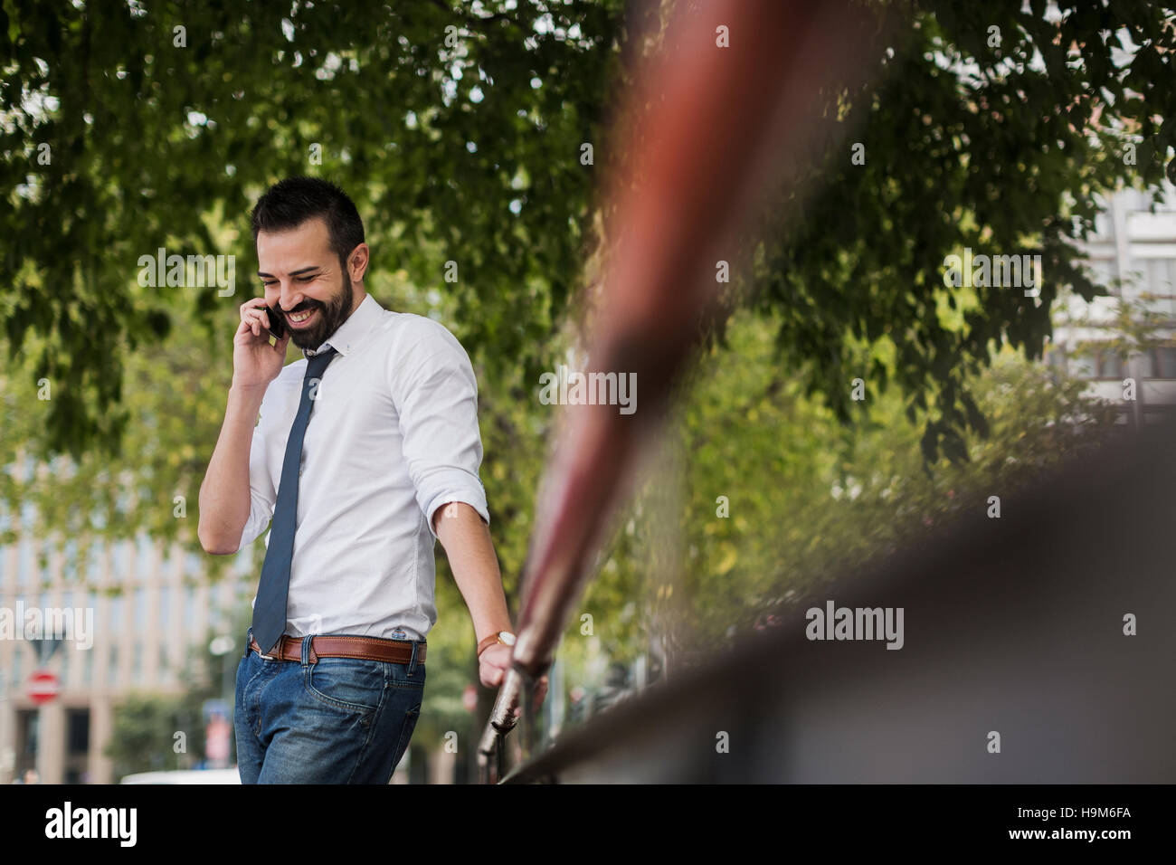 Smiling businessman on the phone Stock Photo - Alamy