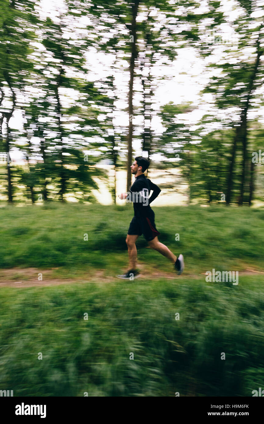 Man running on forest track Stock Photo - Alamy
