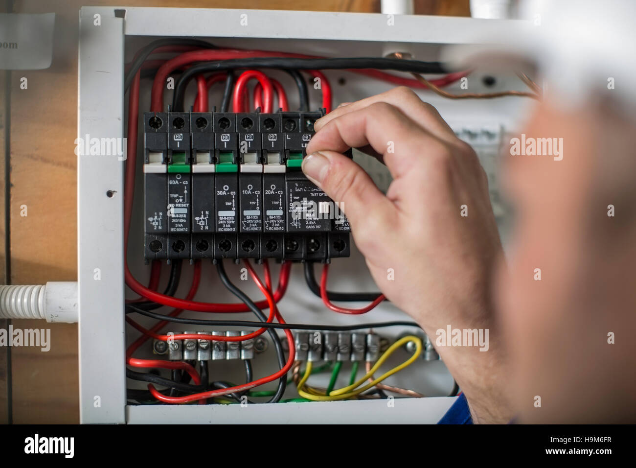 Electrician working on electrical panel Stock Photo - Alamy