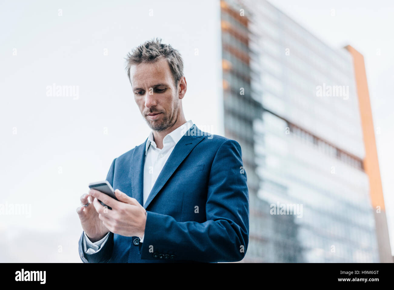 Portrait of businessman using cell phone Stock Photo - Alamy
