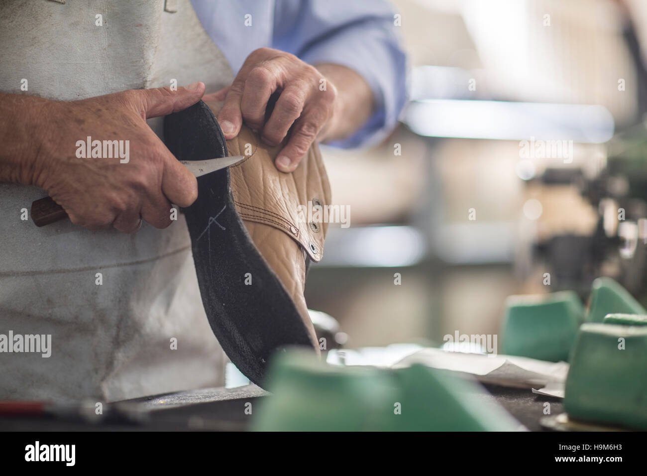Shoemaker working on shoe in workshop Stock Photo - Alamy