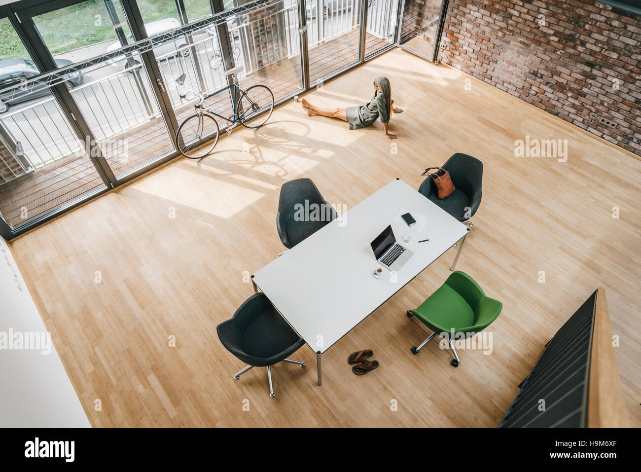 Top view of woman sitting on the floor in boardroom Stock Photo - Alamy