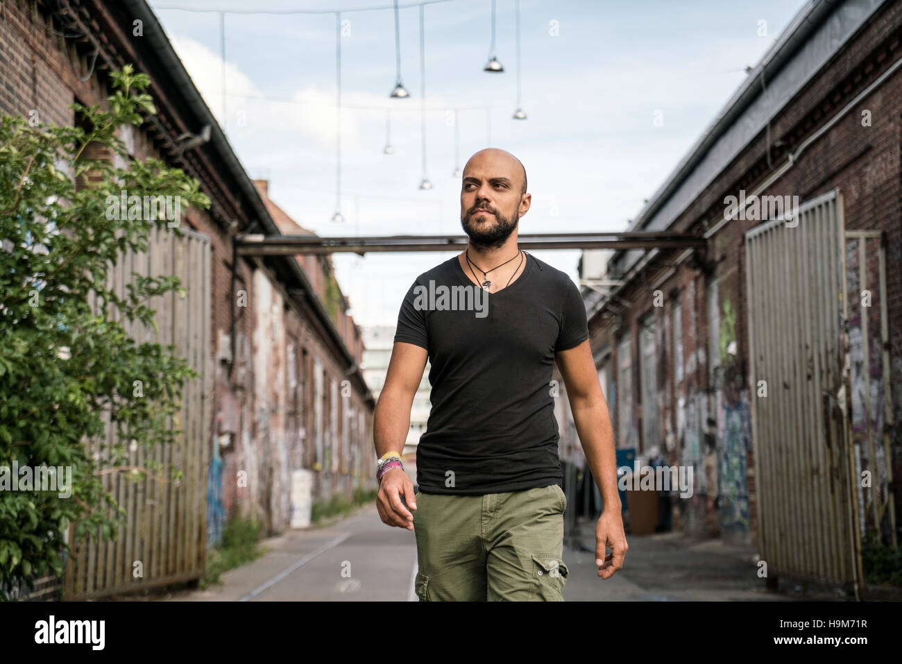 Portrait of walking man watching something Stock Photo - Alamy