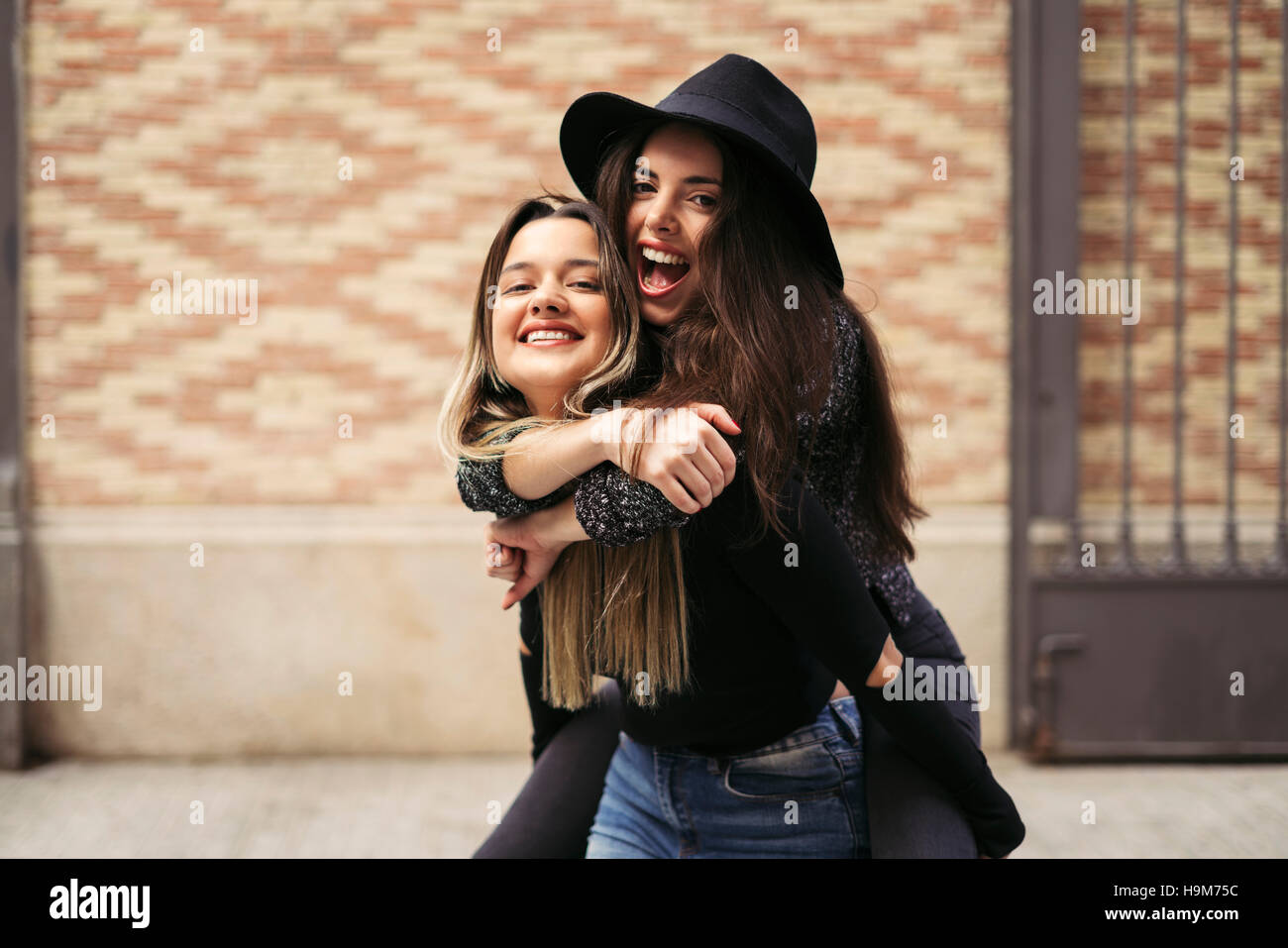 Woman giving her best a friend a piggyback ride Stock Photo - Alamy