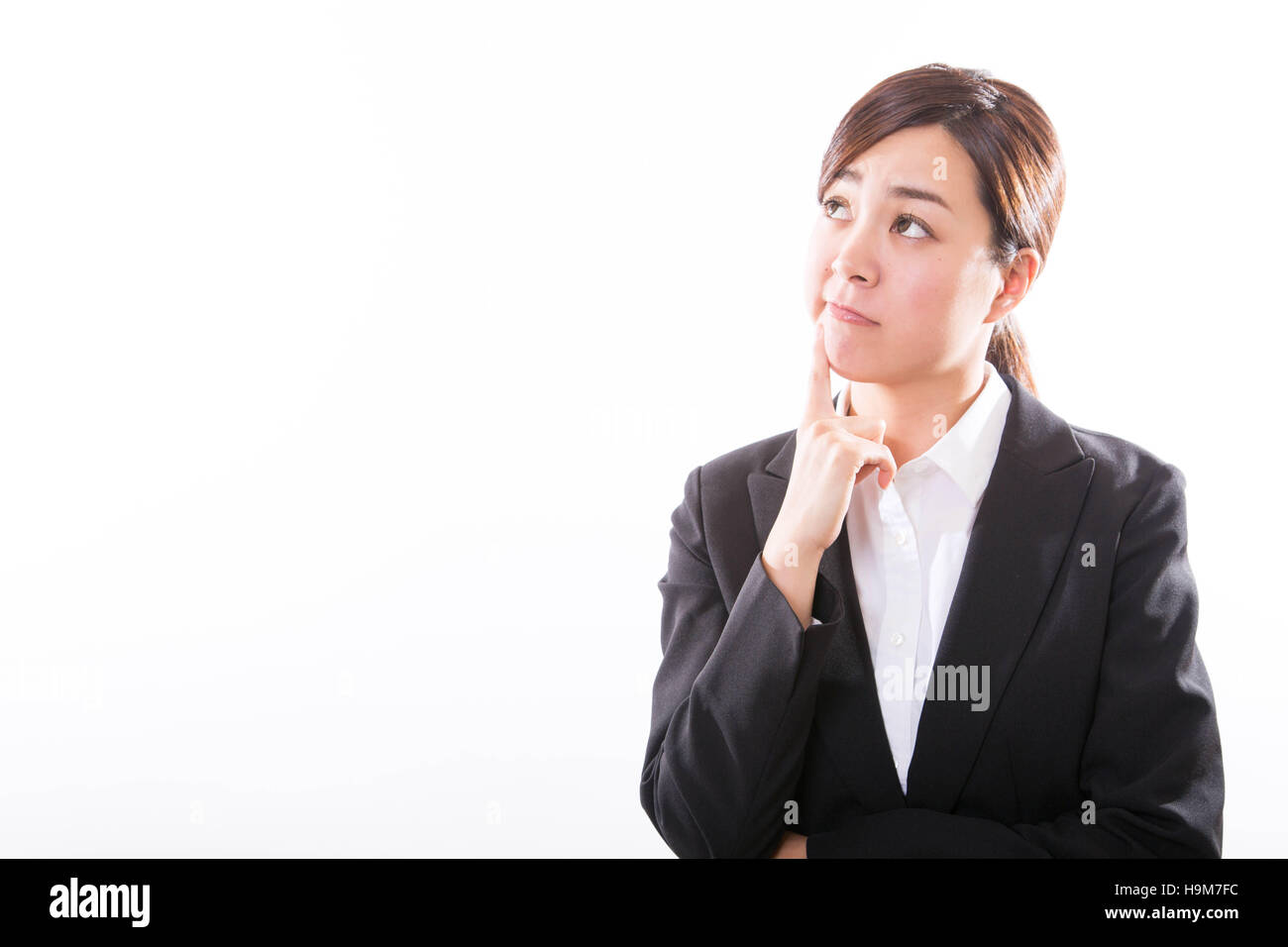 Portrait of a business young woman thinking Stock Photo - Alamy