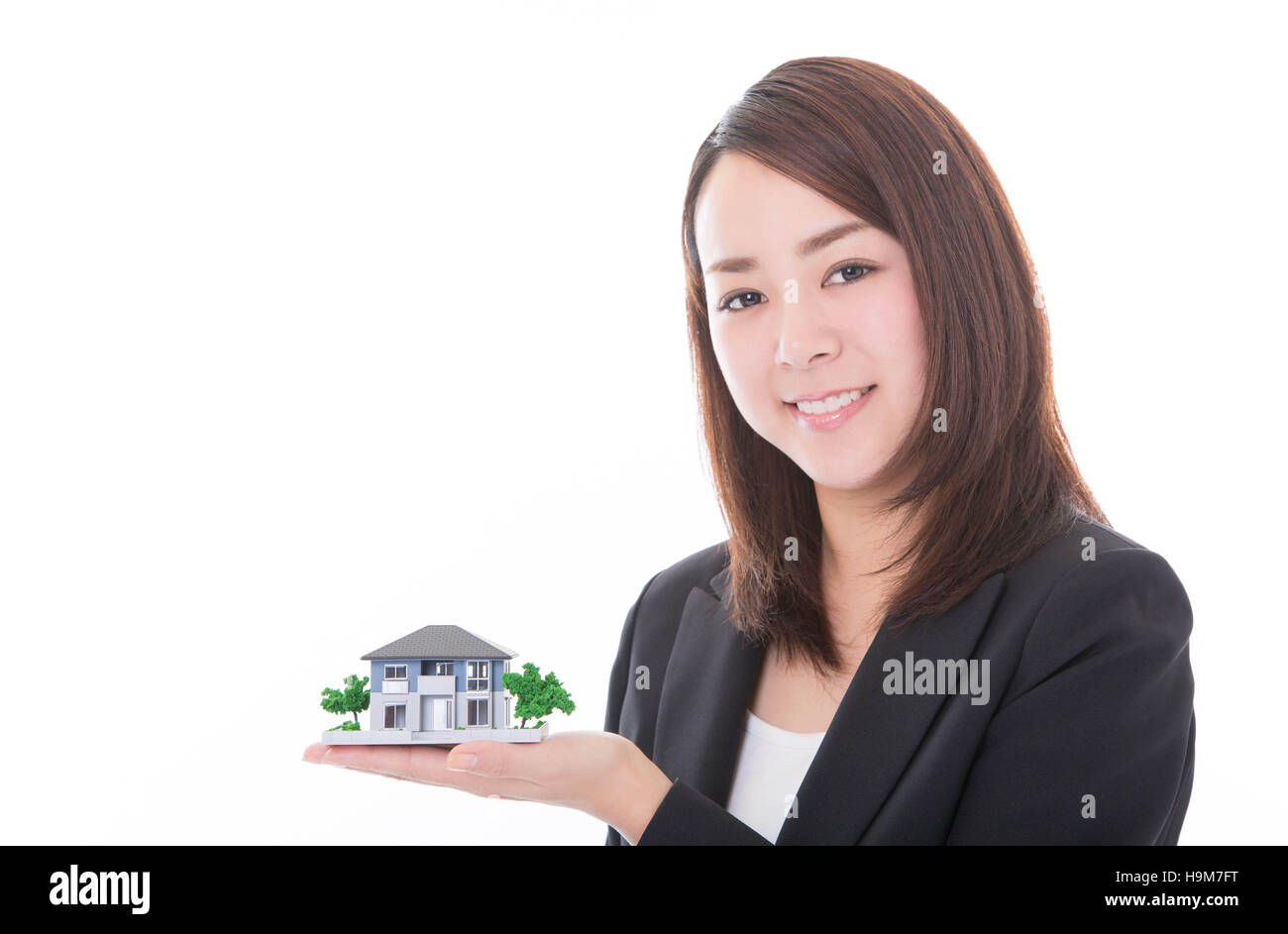 Real estate agent woman with house model Stock Photo - Alamy