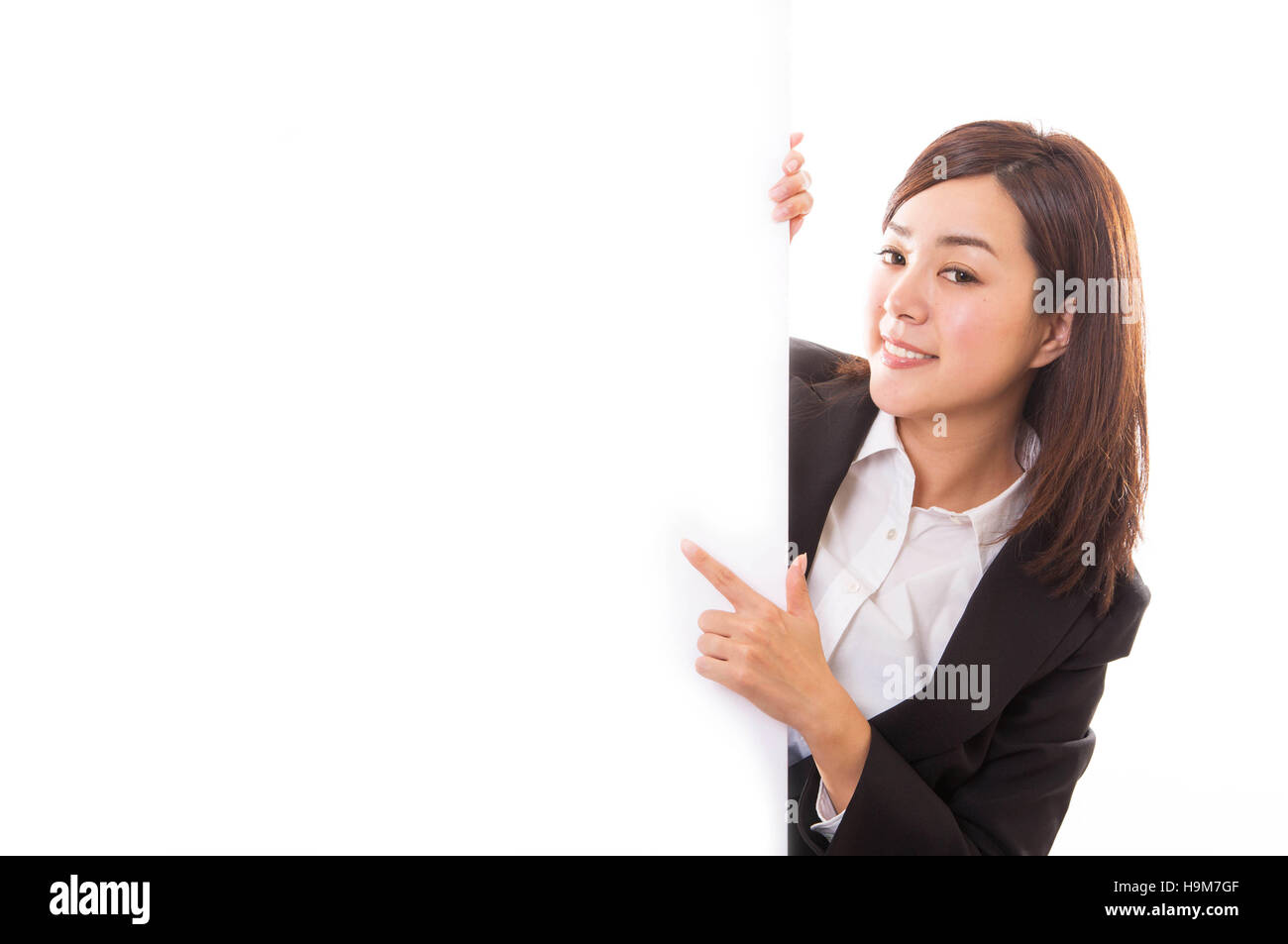 Smiling young business woman pointing empty board while Stock Photo - Alamy