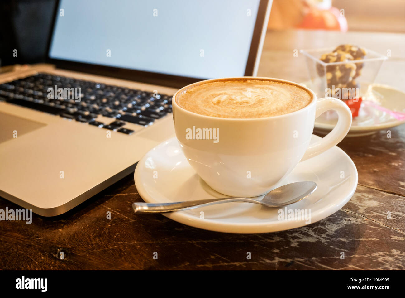 Coffee and laptop working in coffee shop and sun light Stock Photo - Alamy