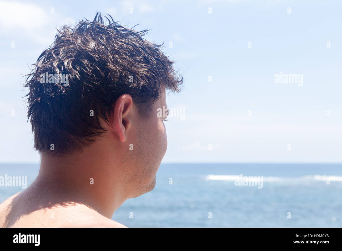a man looks to the blue sea Stock Photo - Alamy