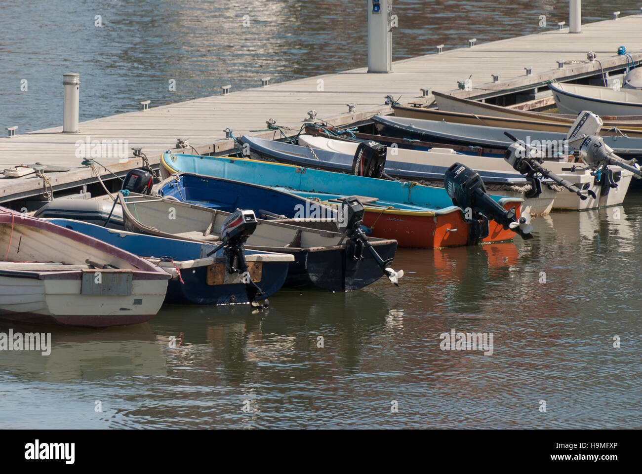Boats tied up at a Jetty Stock Photo - Alamy