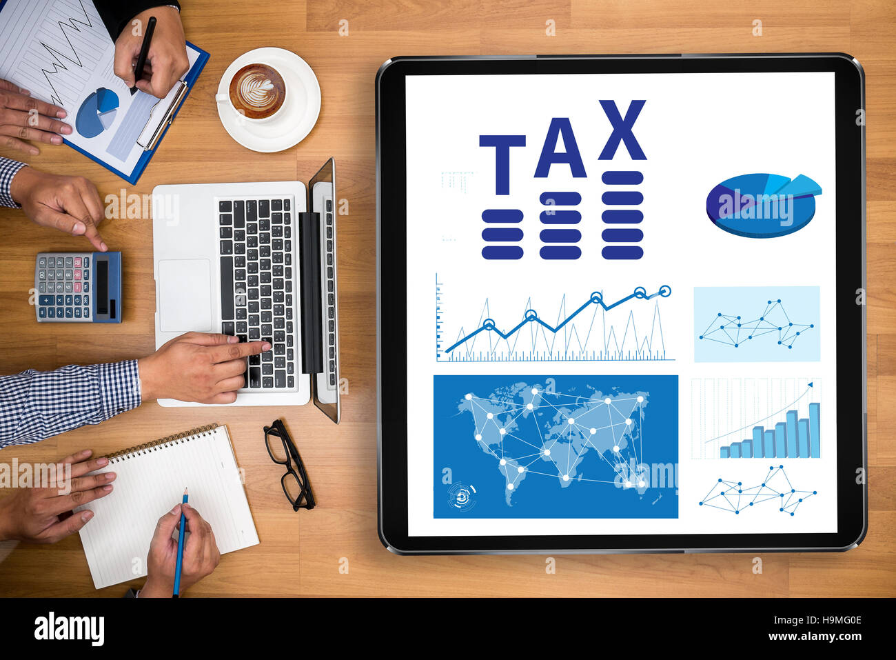 TAX TIME Business team hands at work with financial reports Stock Photo ...